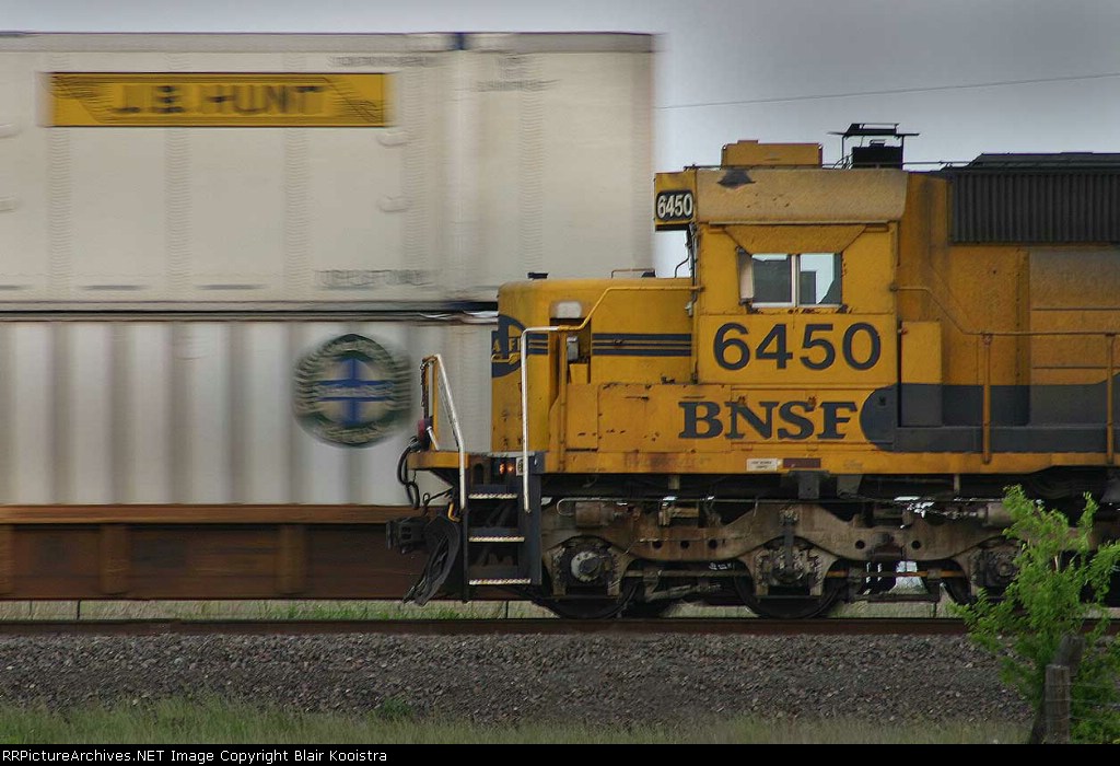 Intermodal train passes BNSF 6450, tied down without a crew, at Haslet, TX